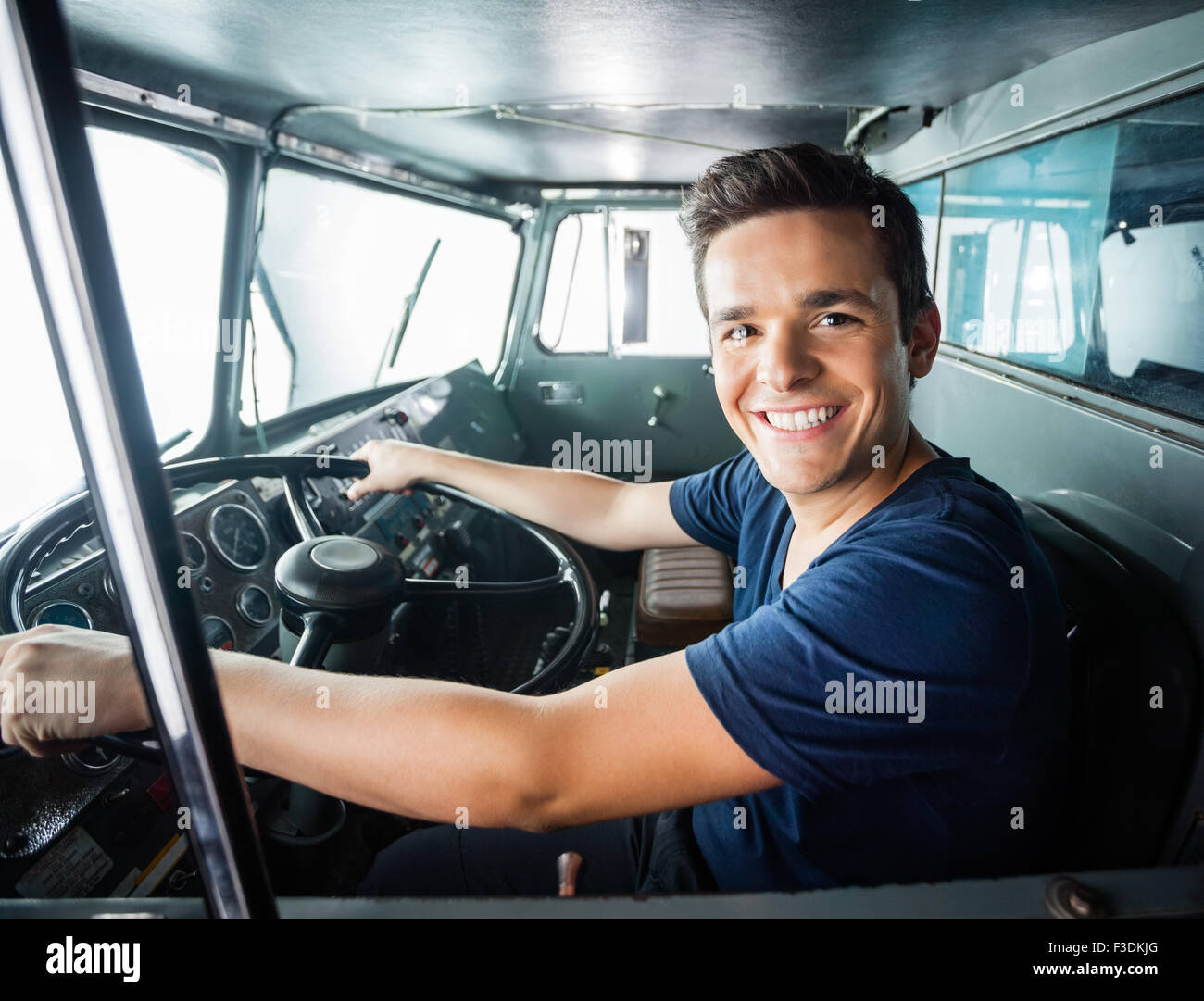 Firefighter driving fire engine young hi-res stock photography and ...