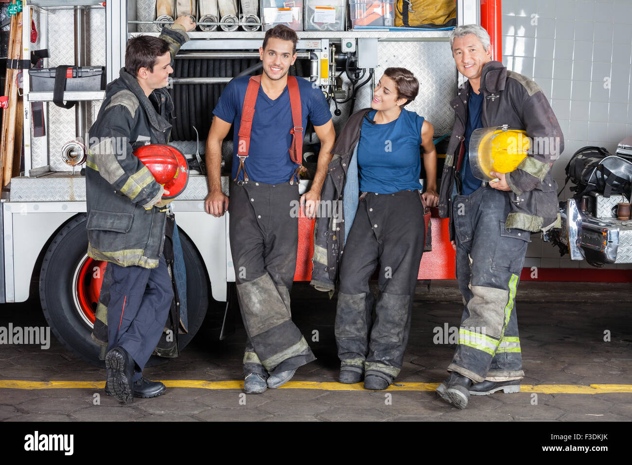 Confident Firefighters Leaning On Truck Stock Photo - Alamy