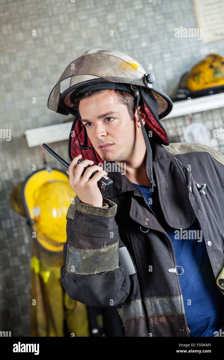 Confident Firefighter Using Walkie Talkie Stock Photo - Alamy
