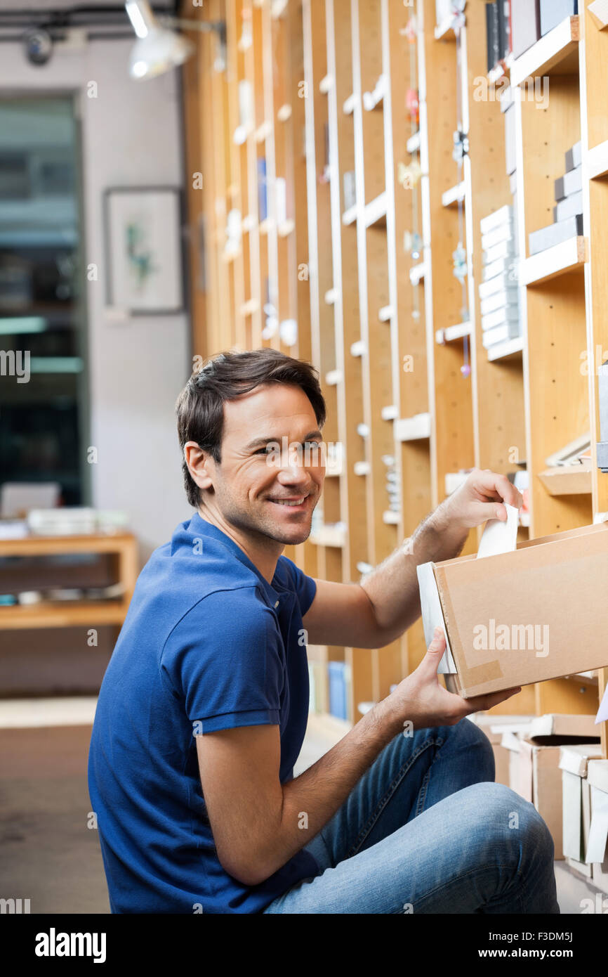 Customer Removing Paper From Cardboard Box Stock Photo - Alamy