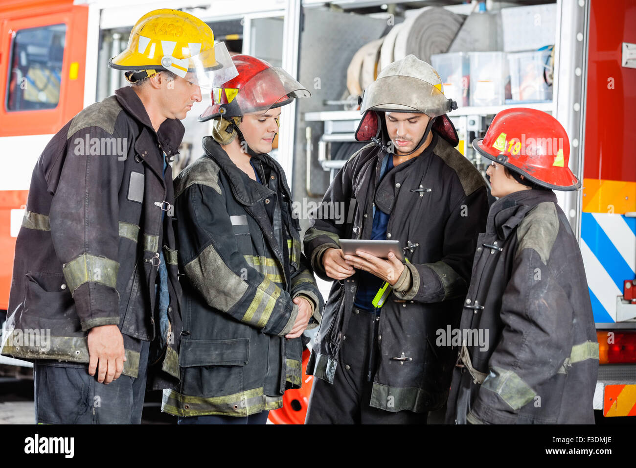 Firefighters Using Tablet Computer At Fire Station Stock Photo - Alamy
