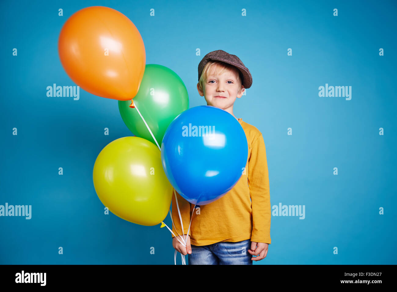 Little boy with balloons looking at camera Stock Photo - Alamy