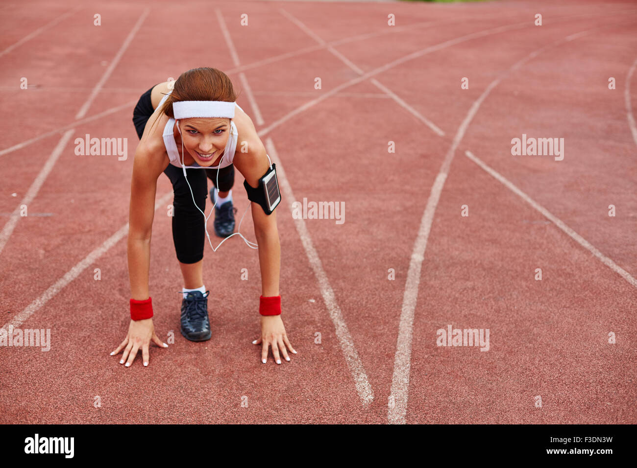 Happy active girl standing at start line Stock Photo - Alamy