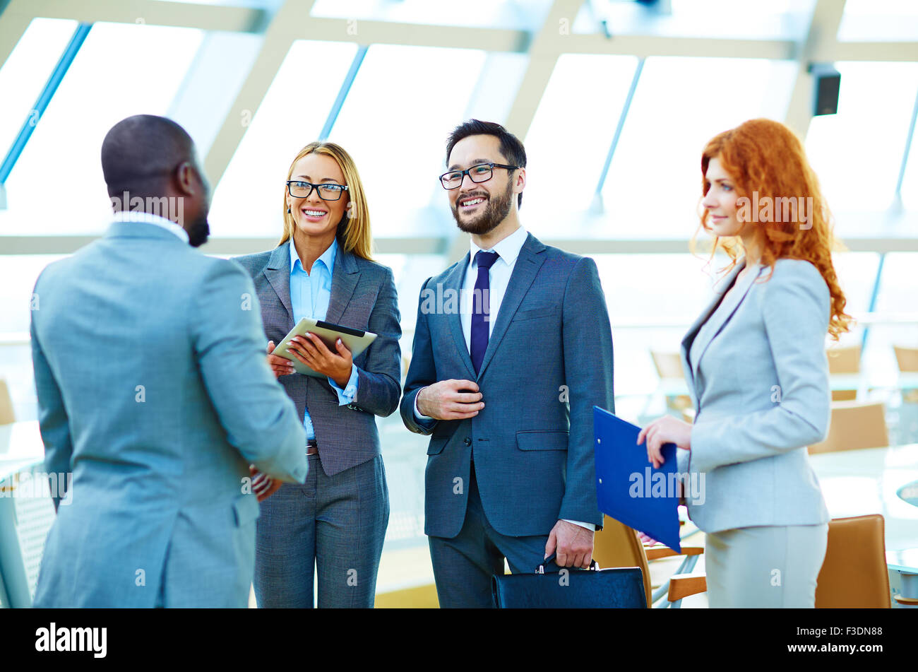 Happy multi-ethnic business people having consultation Stock Photo - Alamy