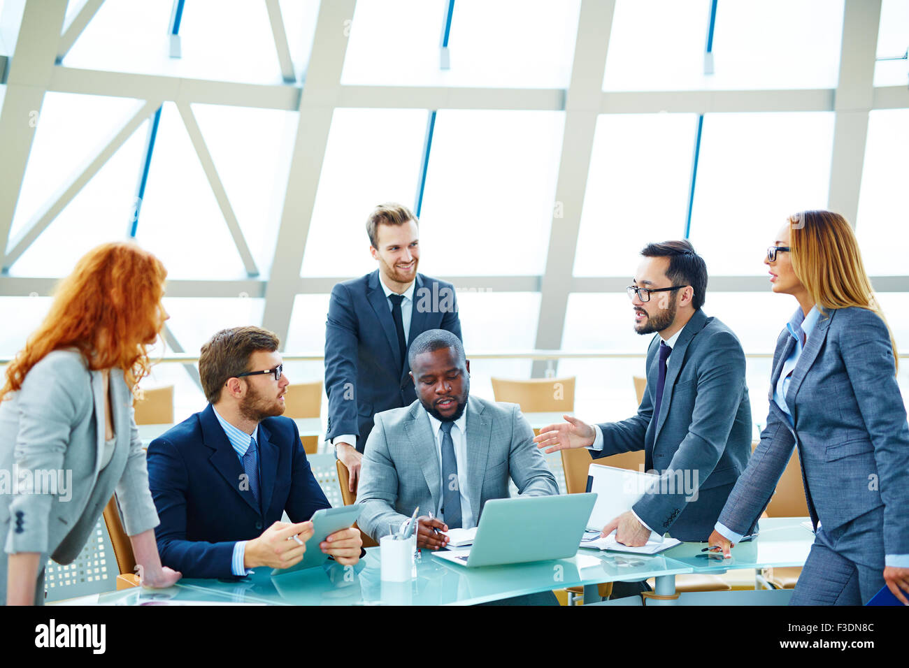 Group of confident employees discussing their ideas at meeting Stock ...