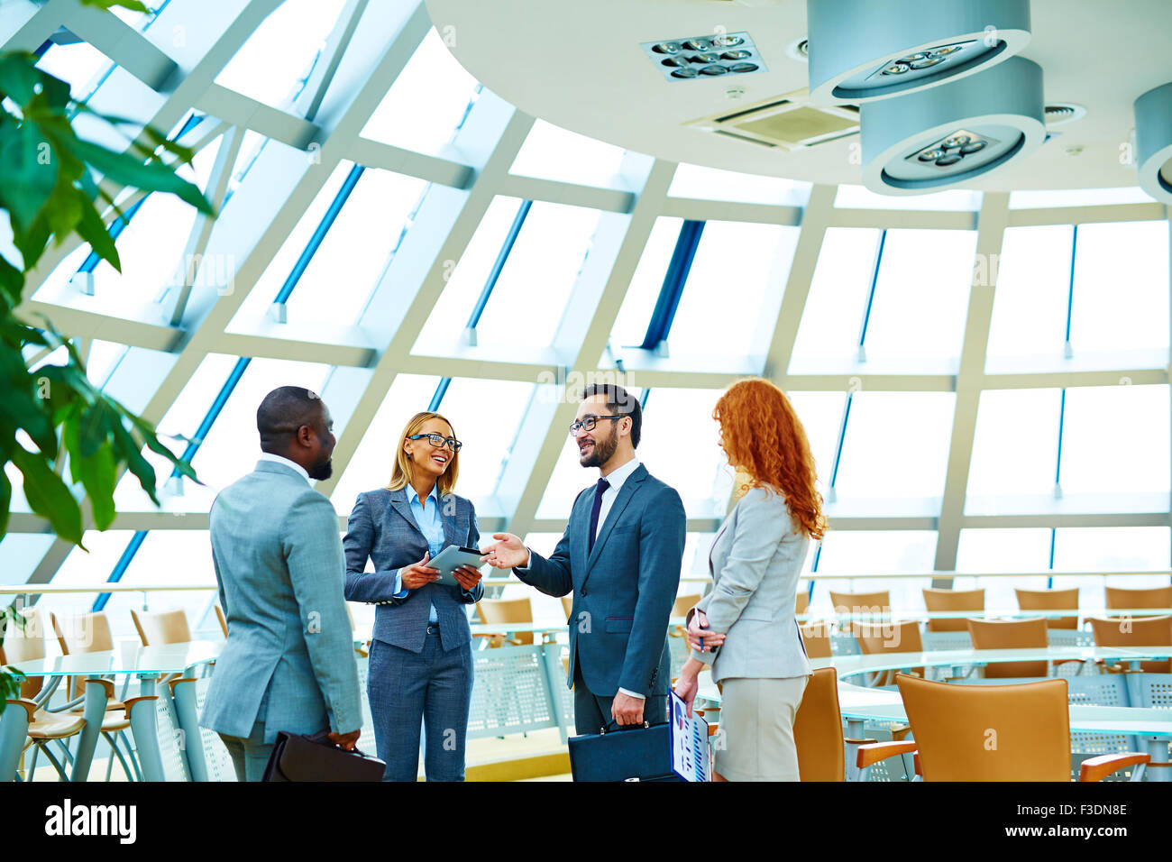 Group of modern employees interacting in office Stock Photo - Alamy