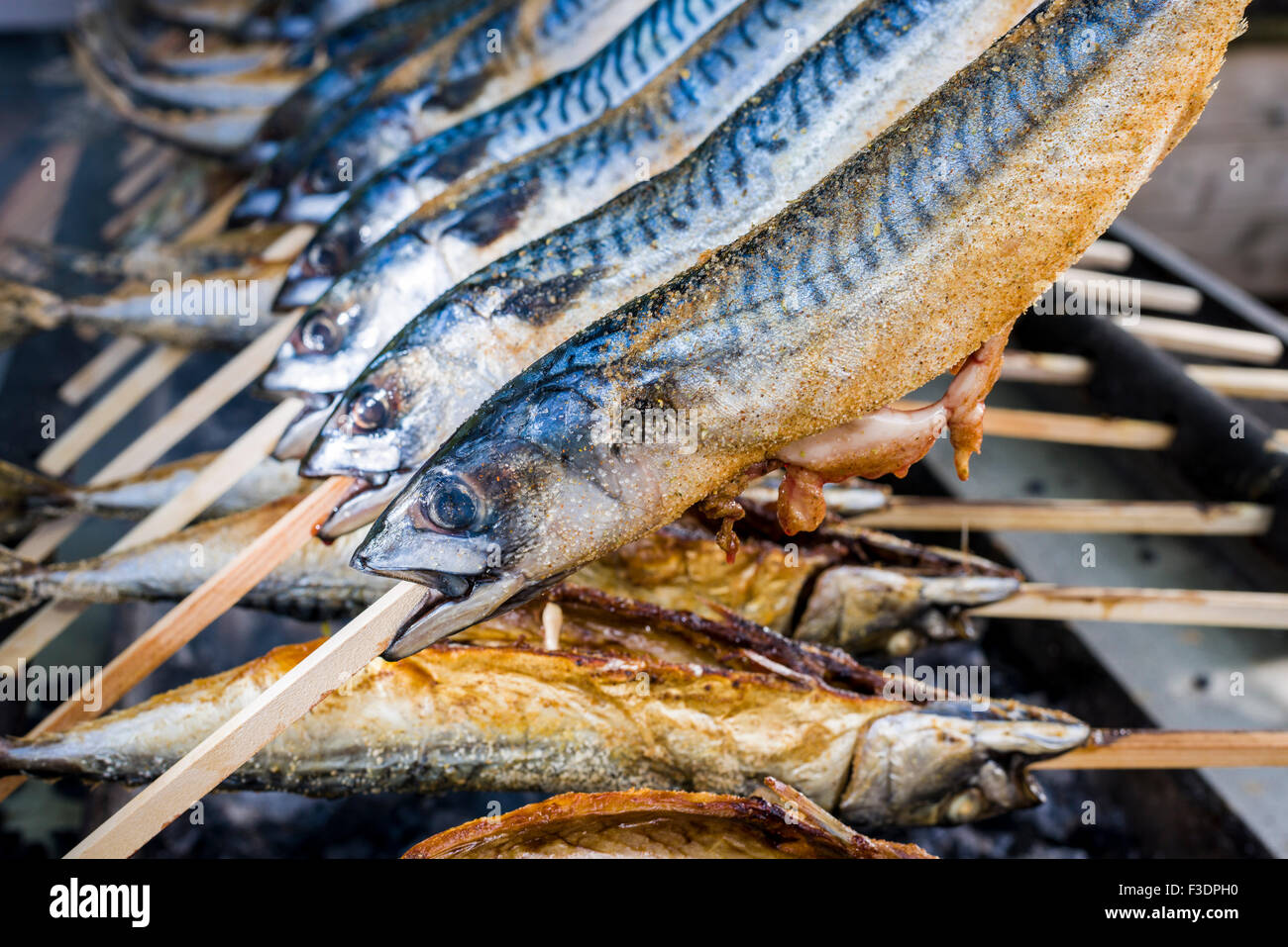 Stockfisch, fish dish prepared on wooden stick being barbecued, Grainau ...