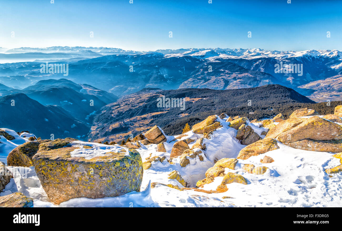White snowy Dolomites mountains with rocks, snow-capped peaks and green ...