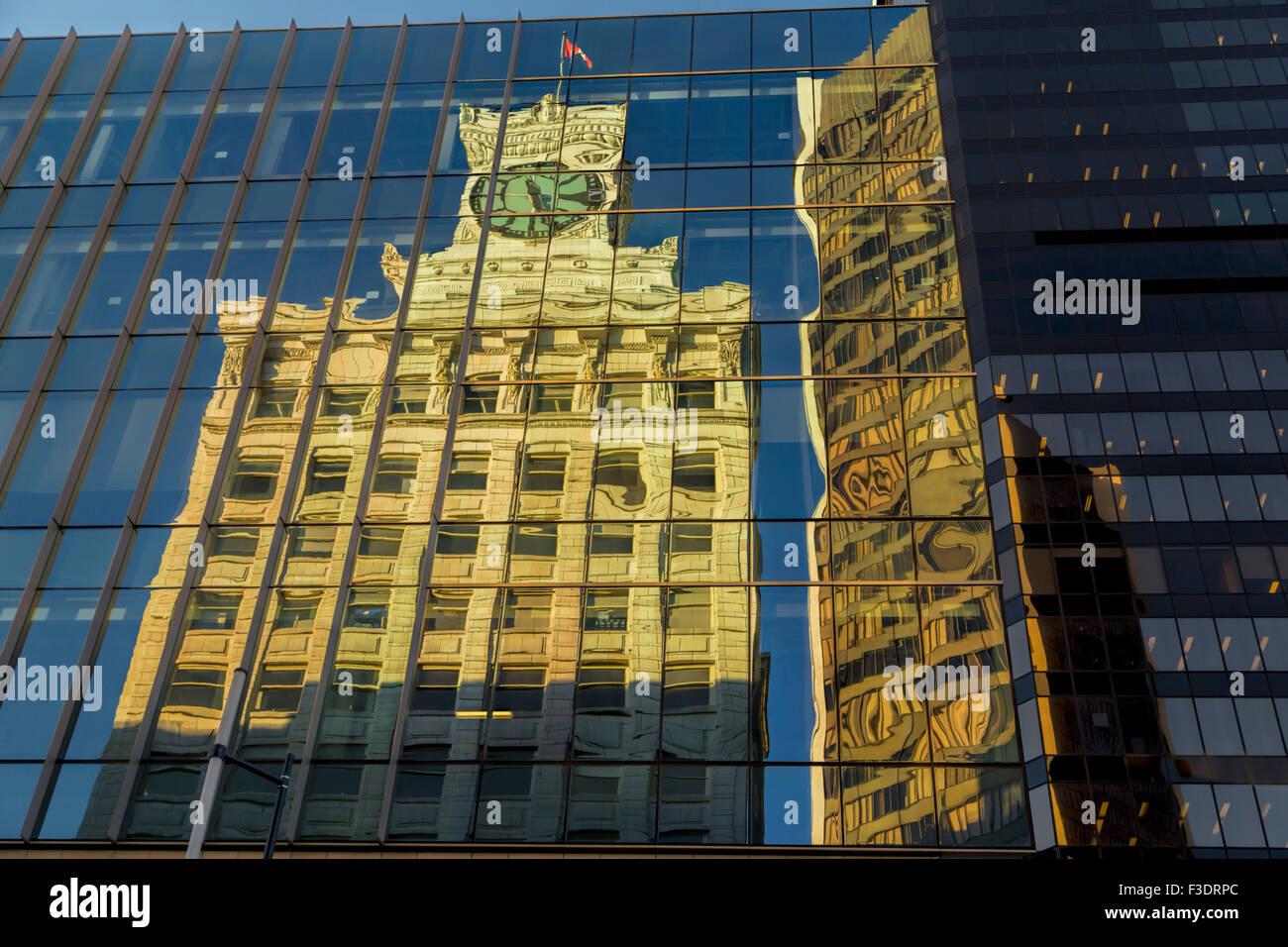 Urban reflections of the The Vancouver Block on the glass facade of a ...