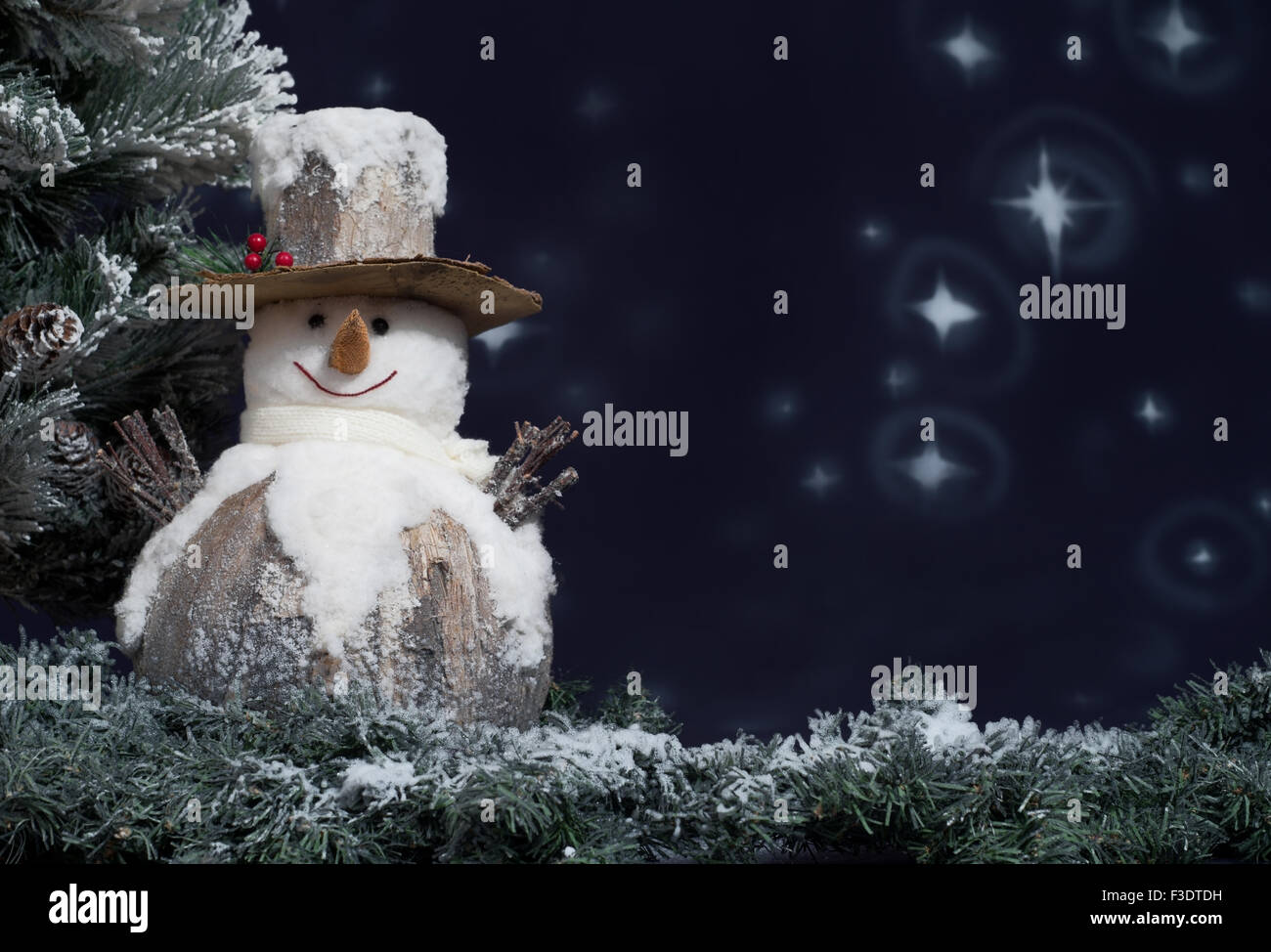 Snowman next to Christmas tree Stock Photo - Alamy