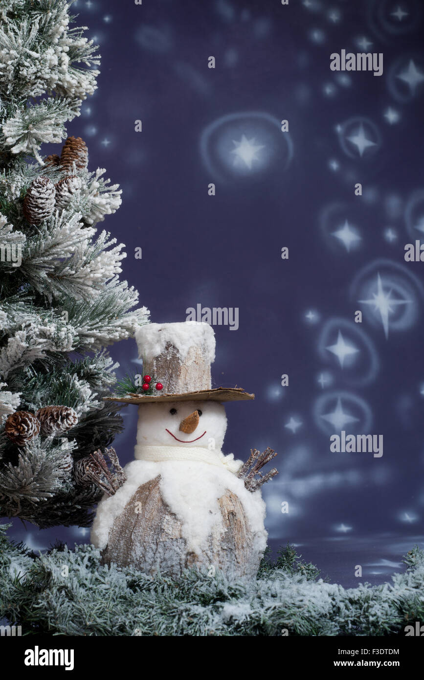 Snowman next to Christmas tree Stock Photo - Alamy