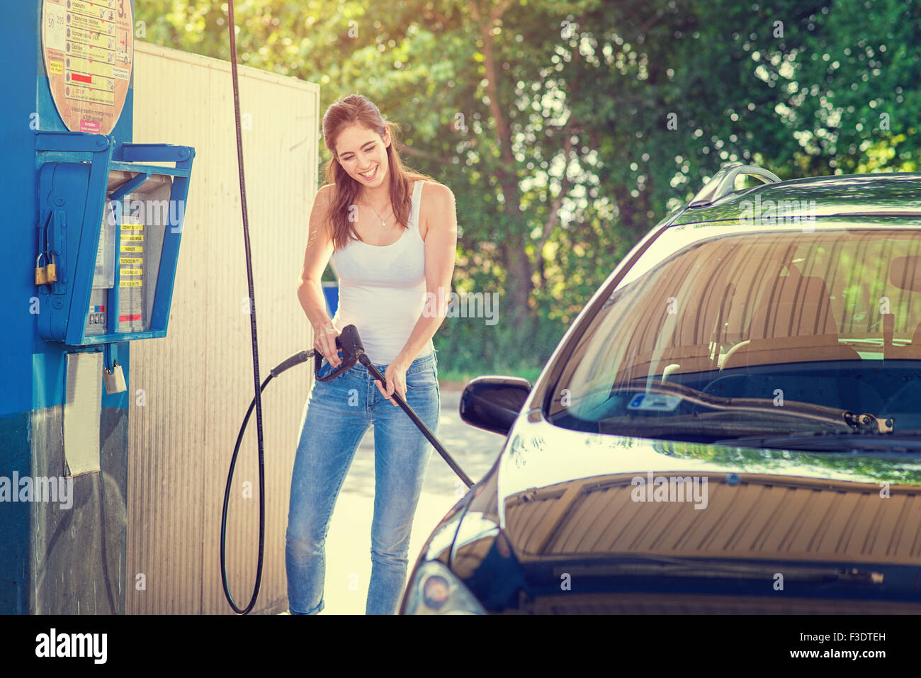 Pretty woman in the car wash - hand wash Stock Photo - Alamy