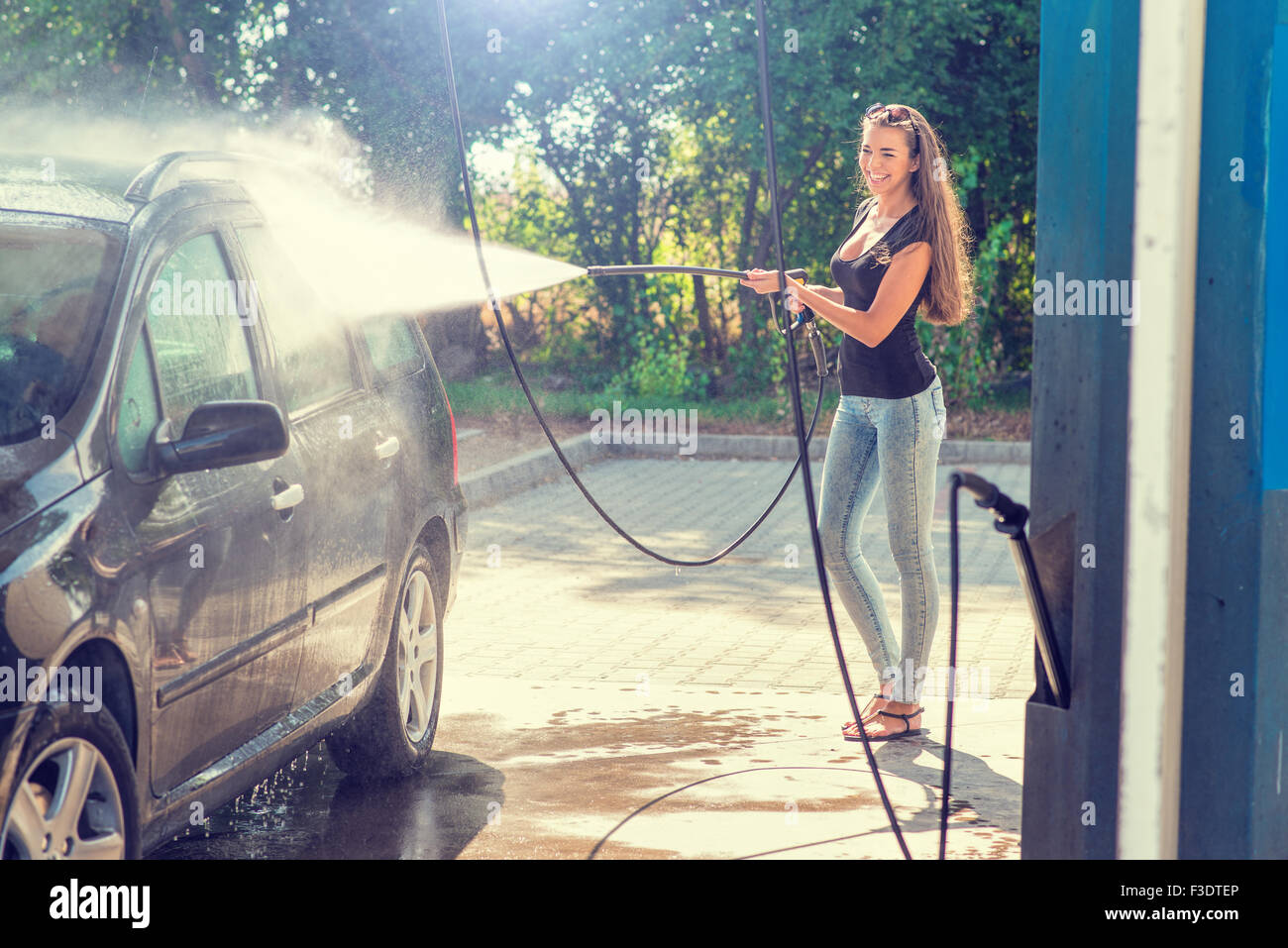 Pretty woman in the car wash - hand wash Stock Photo - Alamy