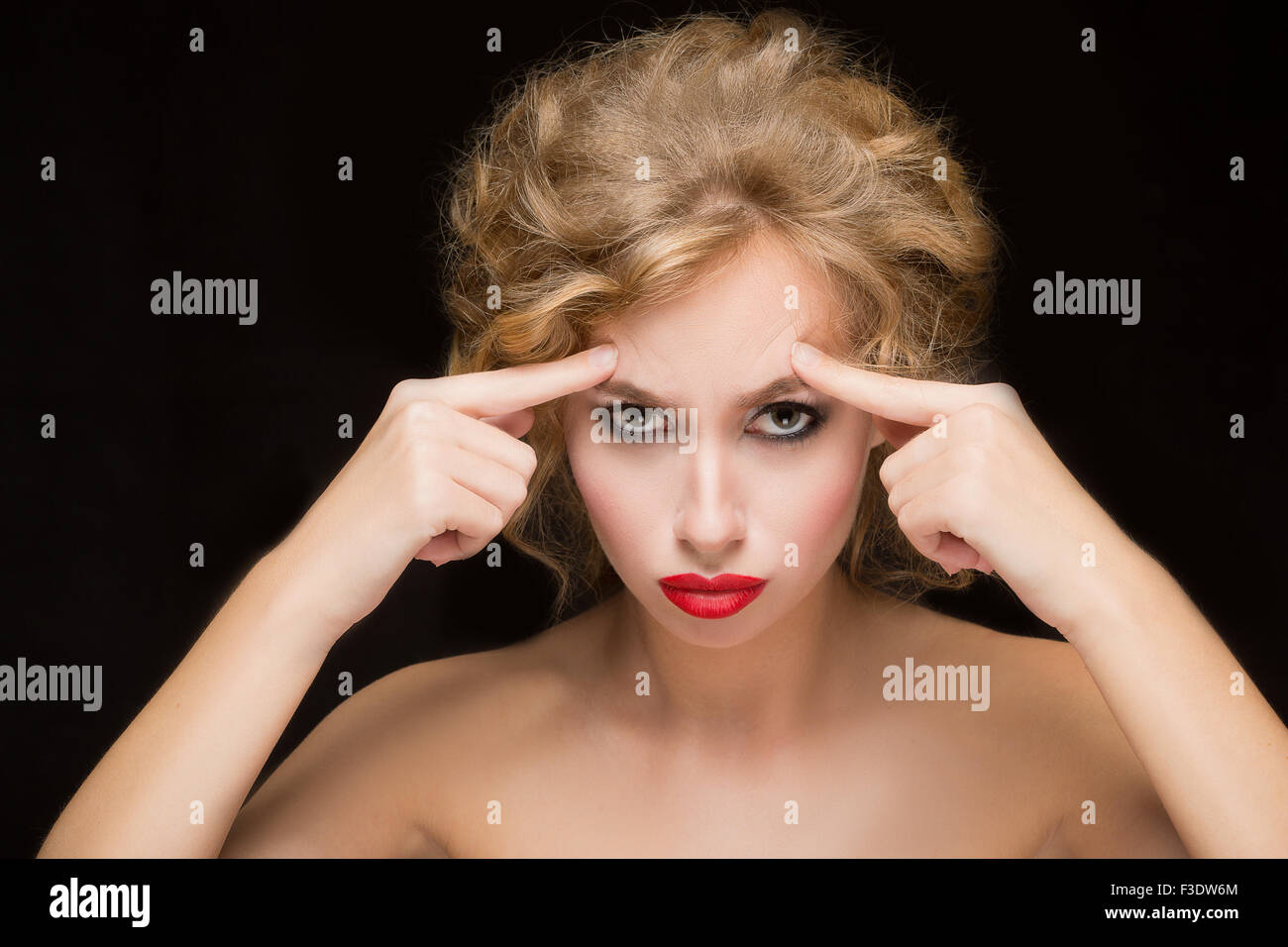 Beautiful woman pointing forehead hi-res stock photography and images ...