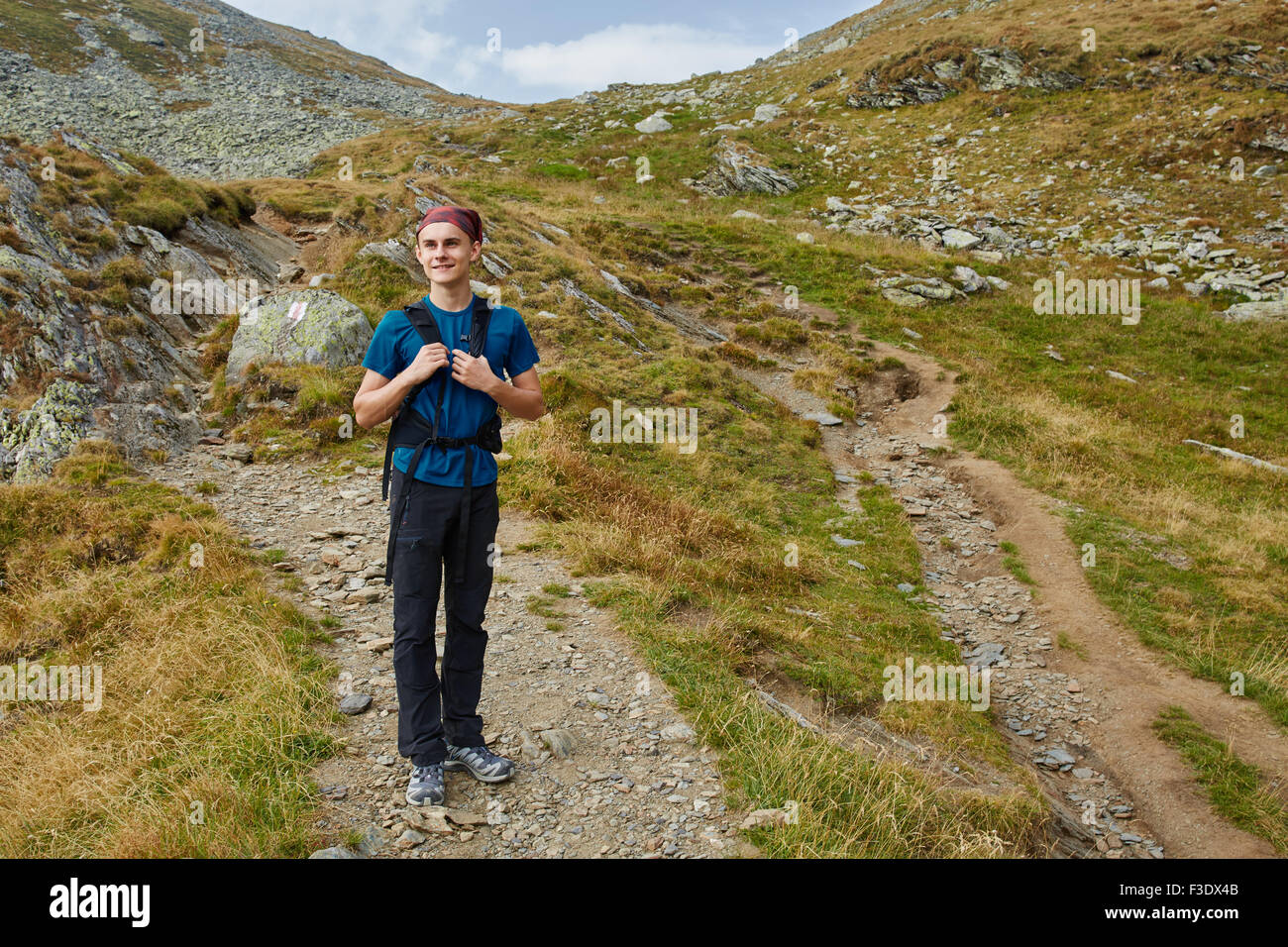 Teenager boy with backpack hiking on a mountain trail Stock Photo - Alamy