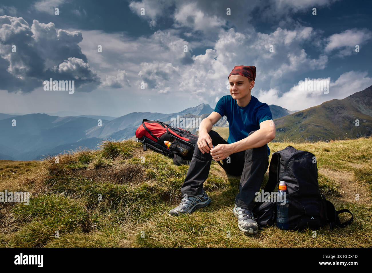 Teenager boy with backpack hiking on a mountain trail Stock Photo - Alamy