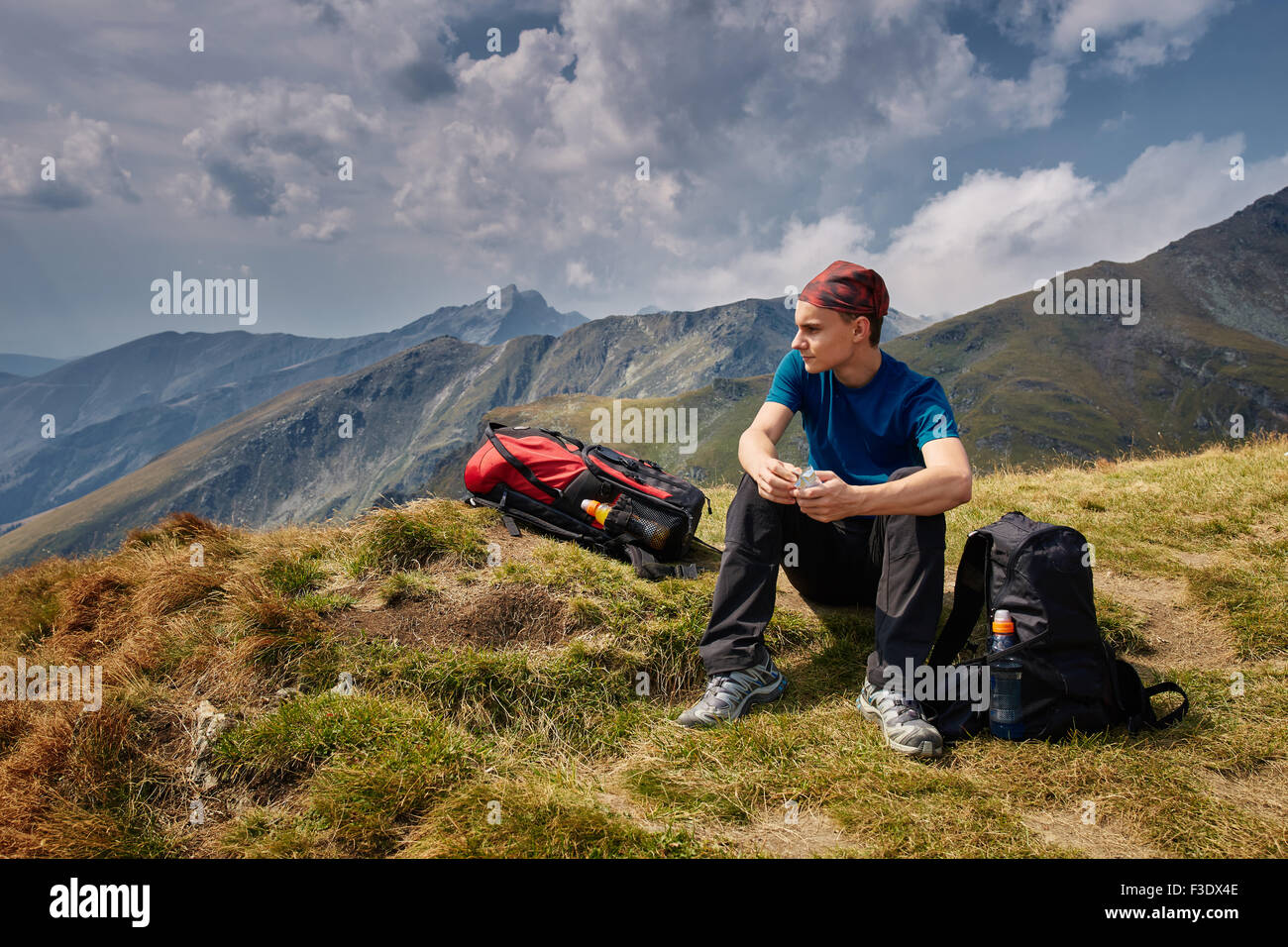 Teenager boy with backpack hiking on a mountain trail Stock Photo - Alamy