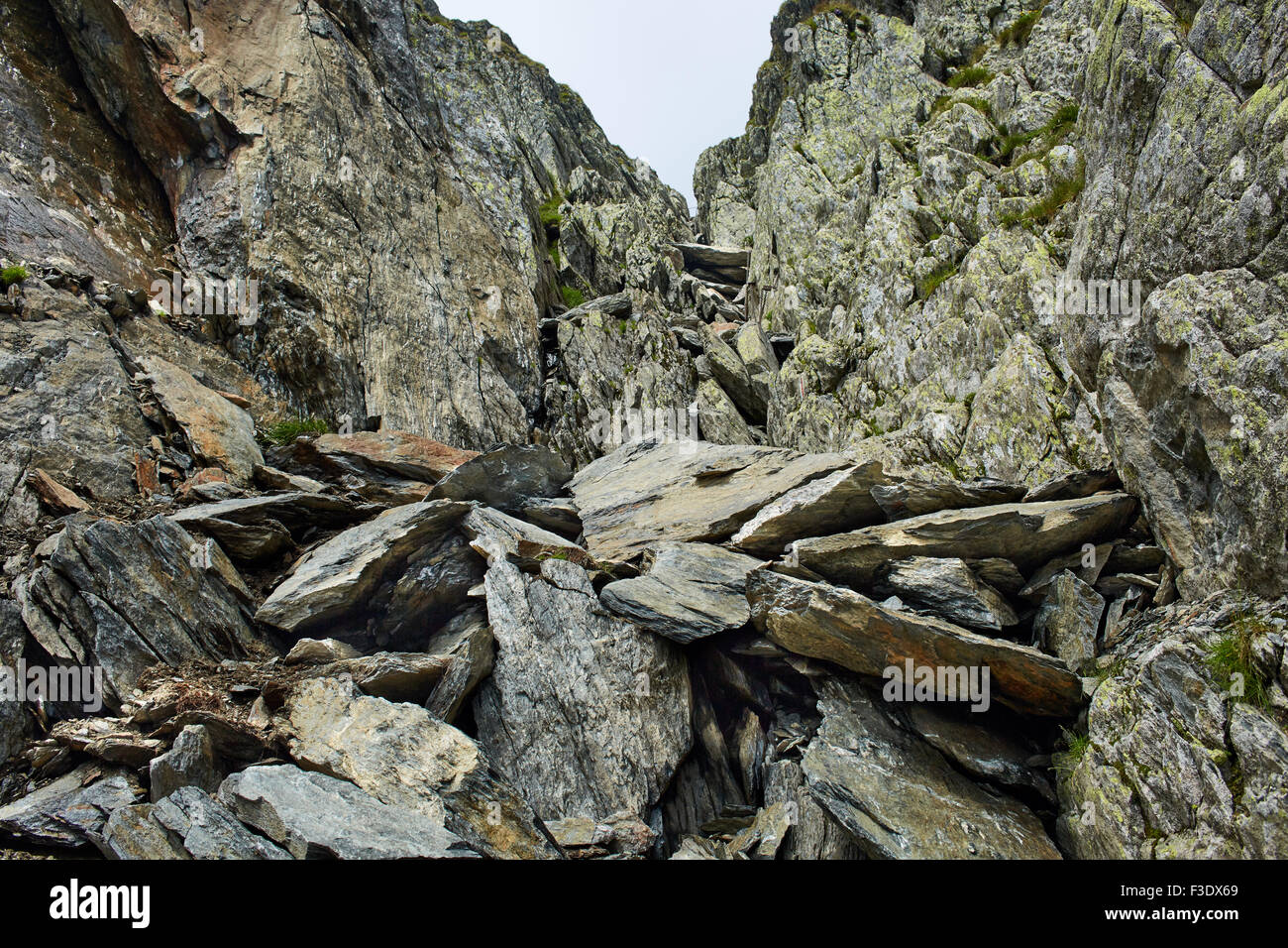 A difficult mountain trail through rocky walls and boulders Stock Photo ...
