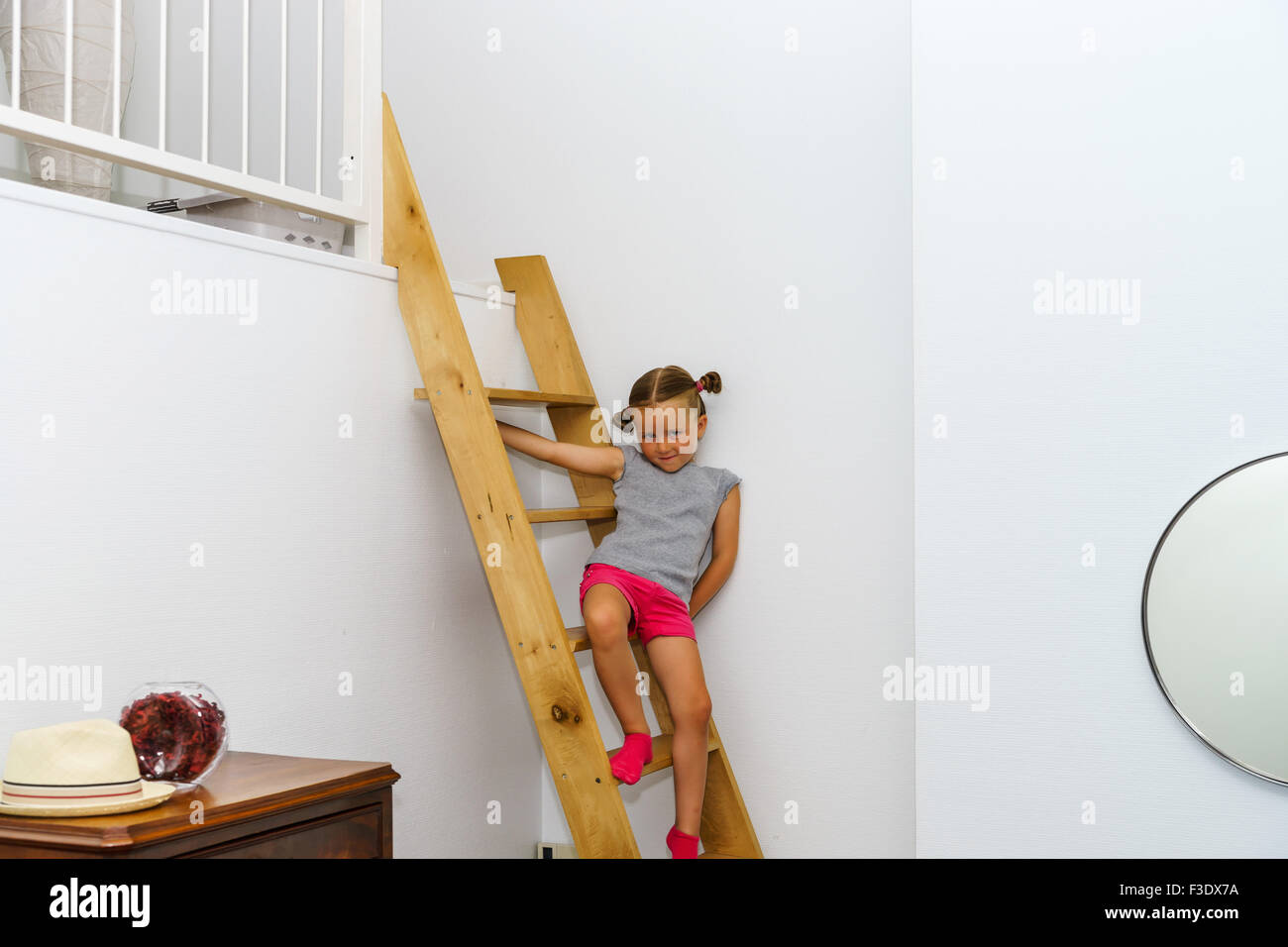 Cute little girl posing indoor on staircase Stock Photo - Alamy