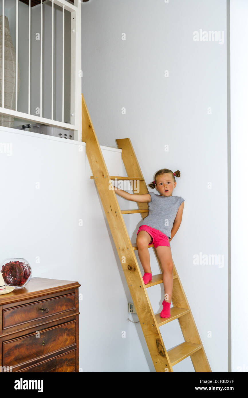 Cute little girl posing indoor on staircase Stock Photo - Alamy
