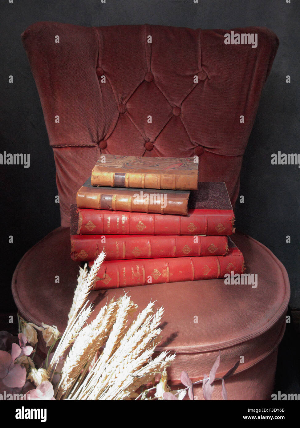 Books stacked on chair Stock Photo - Alamy