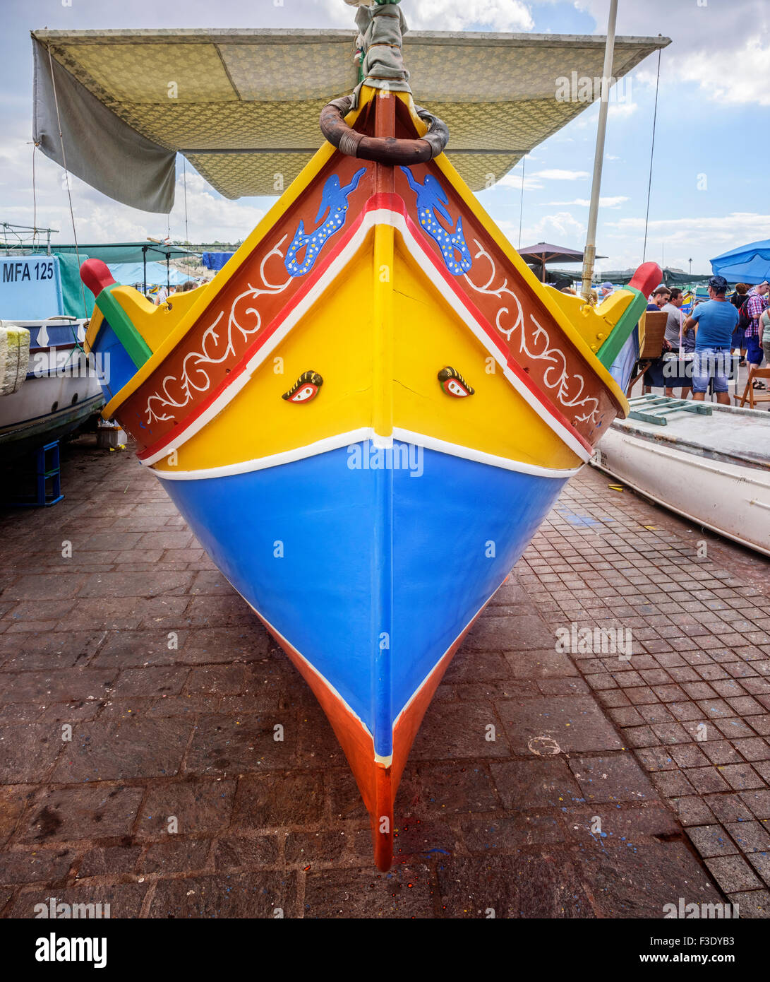 Colourful boats called Luzzus in Marsaxlokk. A luzzu is a traditional ...