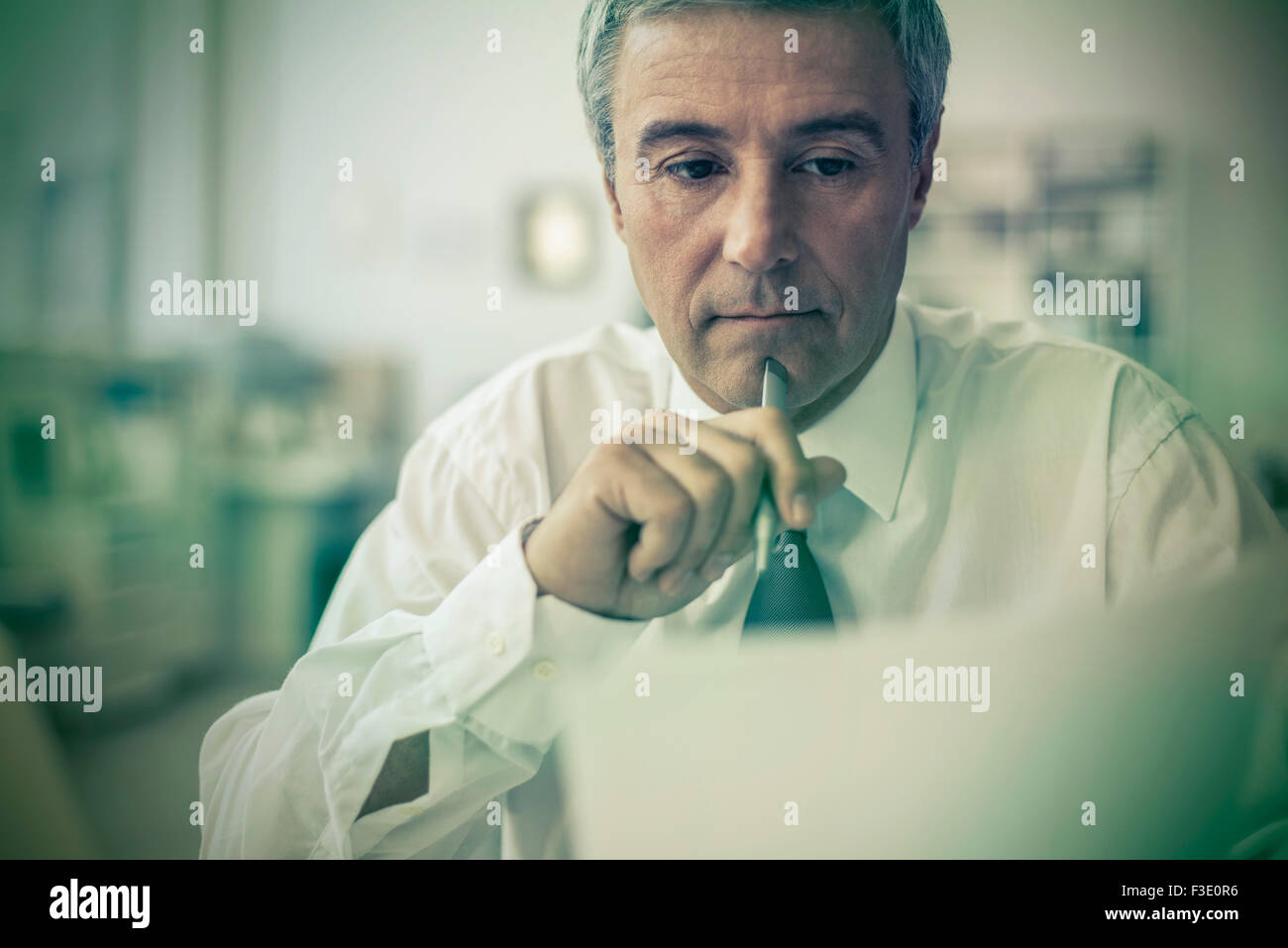 Mature businessman reading document Stock Photo - Alamy Mature businessman reading document Stock Photo - Alamy
