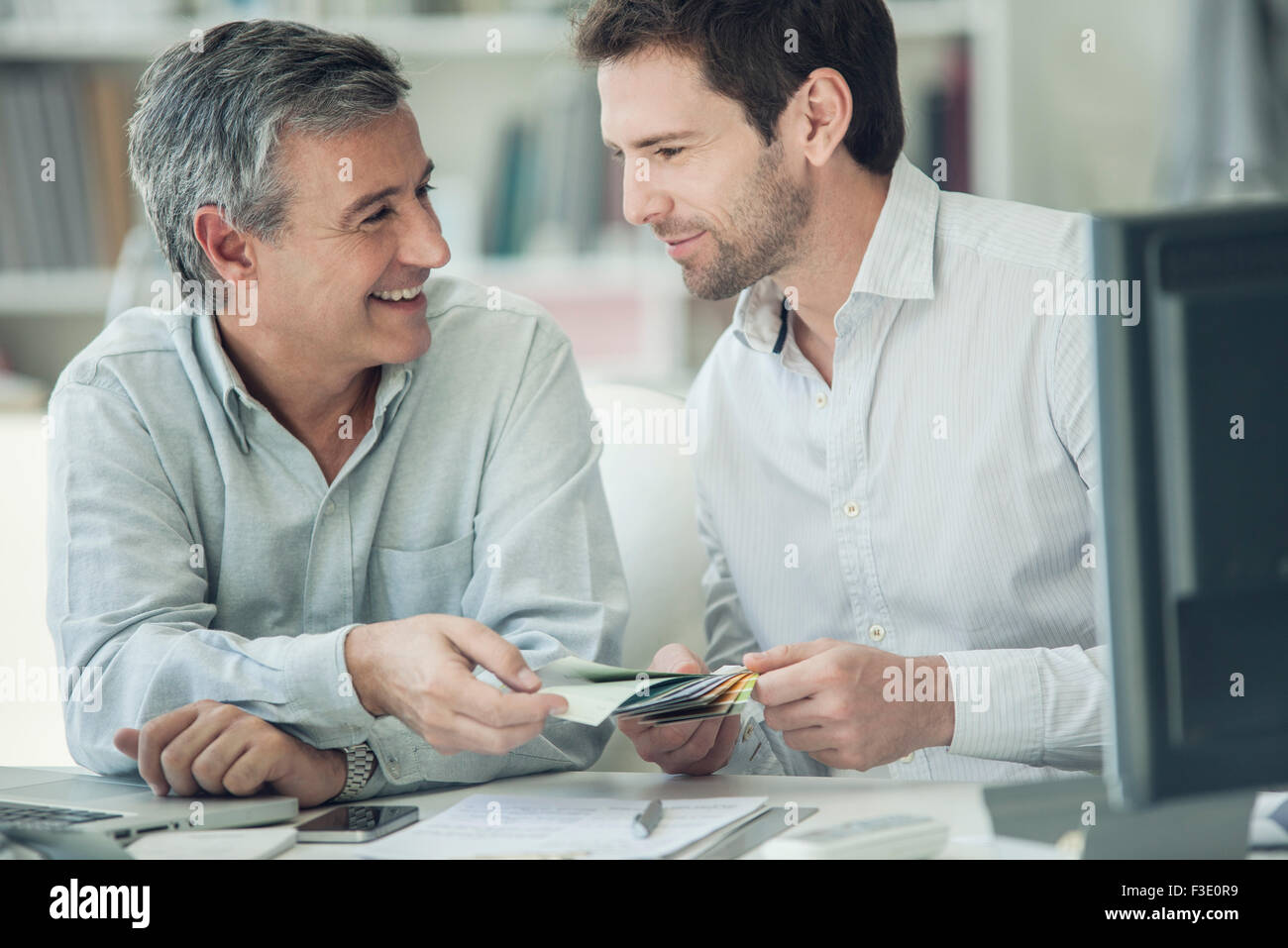 Colleagues looking at color swatches together Stock Photo - Alamy