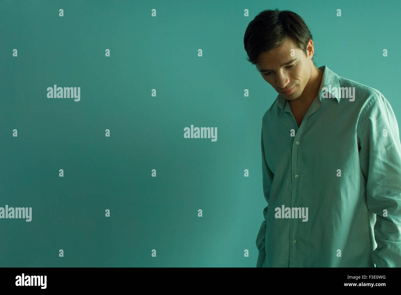 Man smiling, looking down Stock Photo - Alamy
