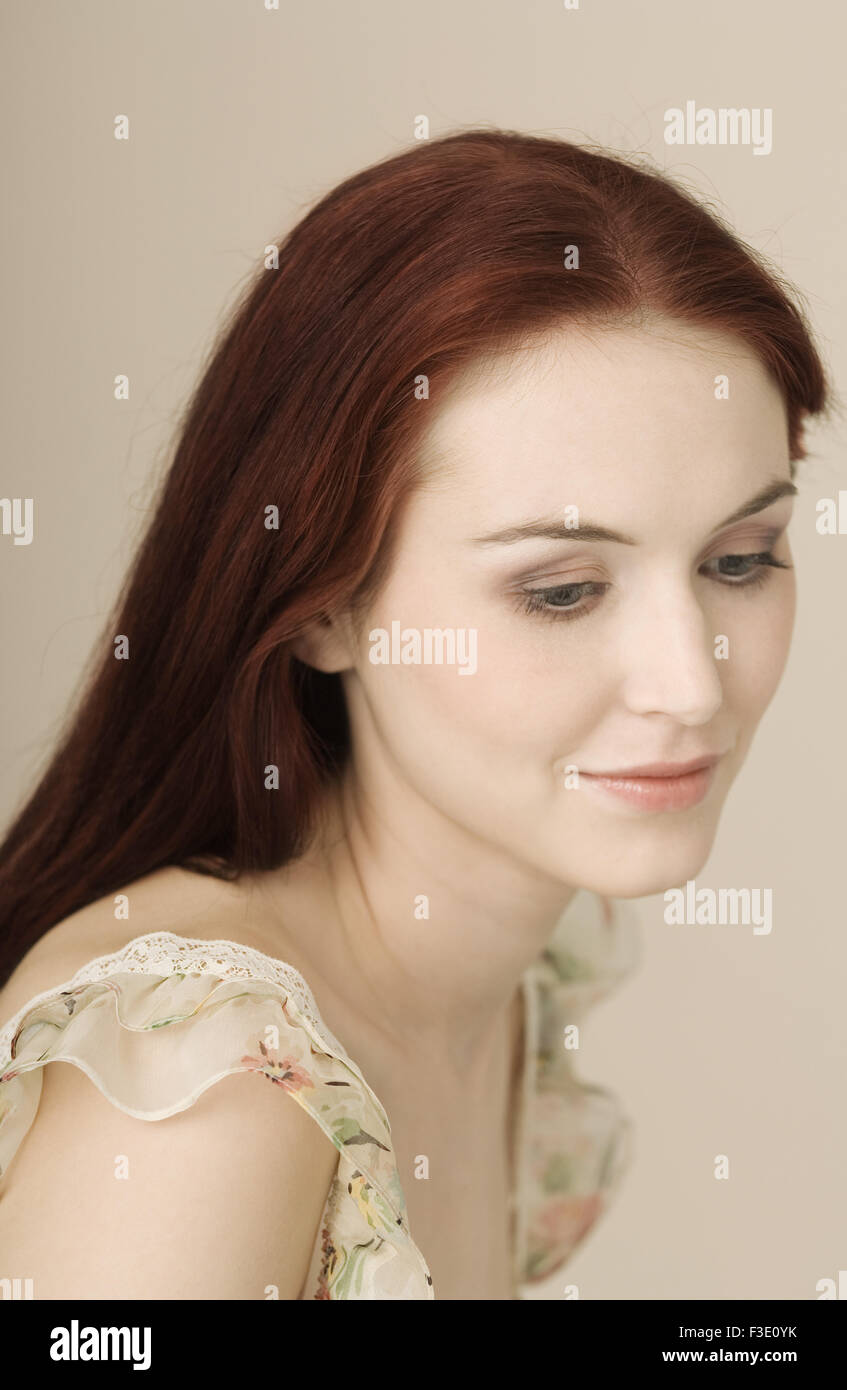 Woman looking down in thought, portrait Stock Photo - Alamy