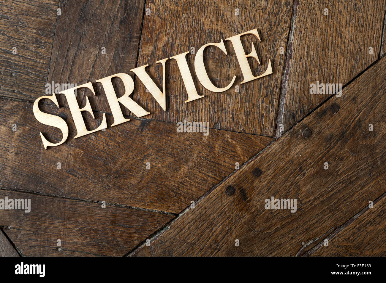 Wooden letters forming word SERVICE written on old vintage wooden ...