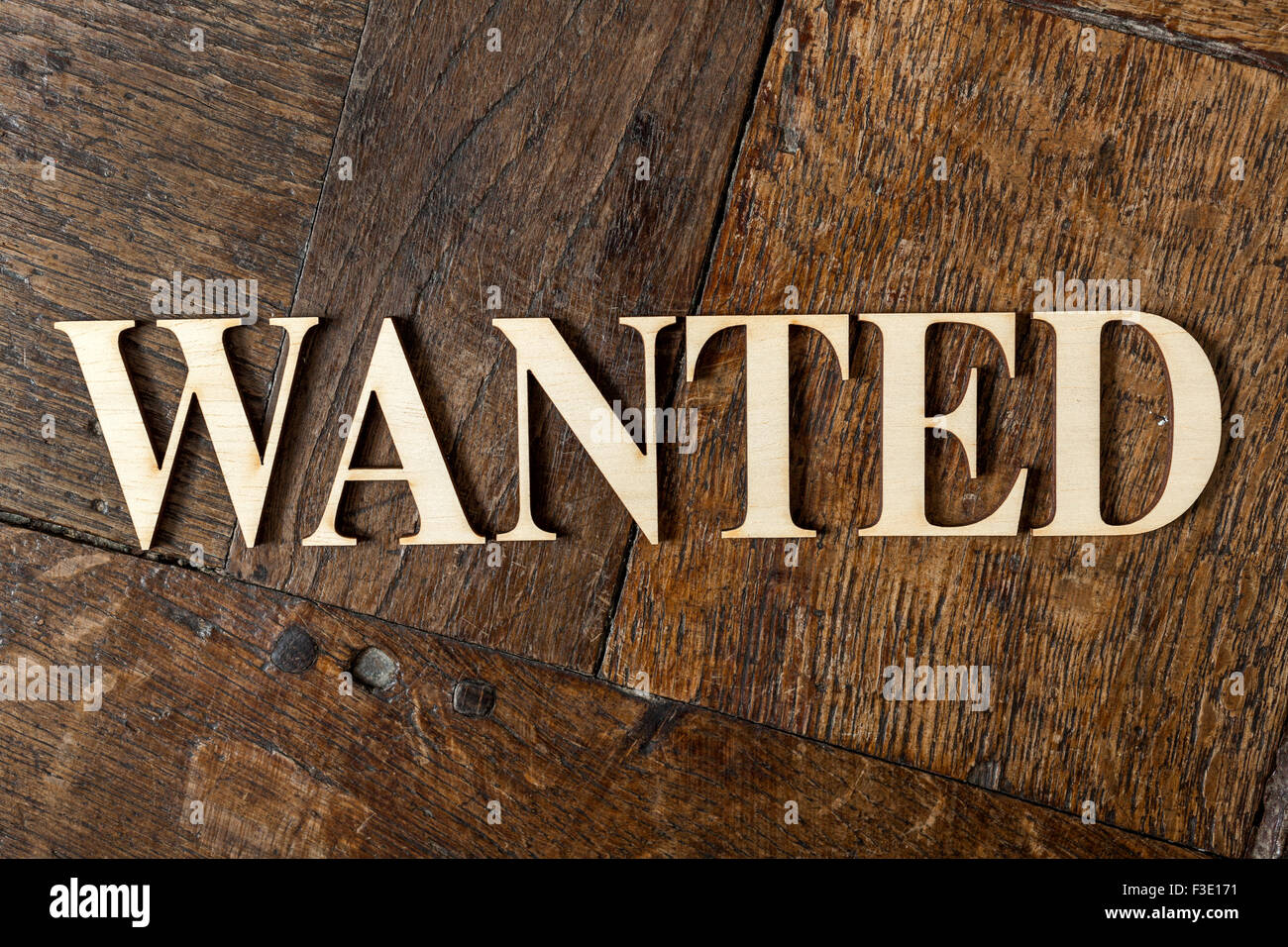 Wooden letters forming word WANTED written on old vintage wooden plates ...