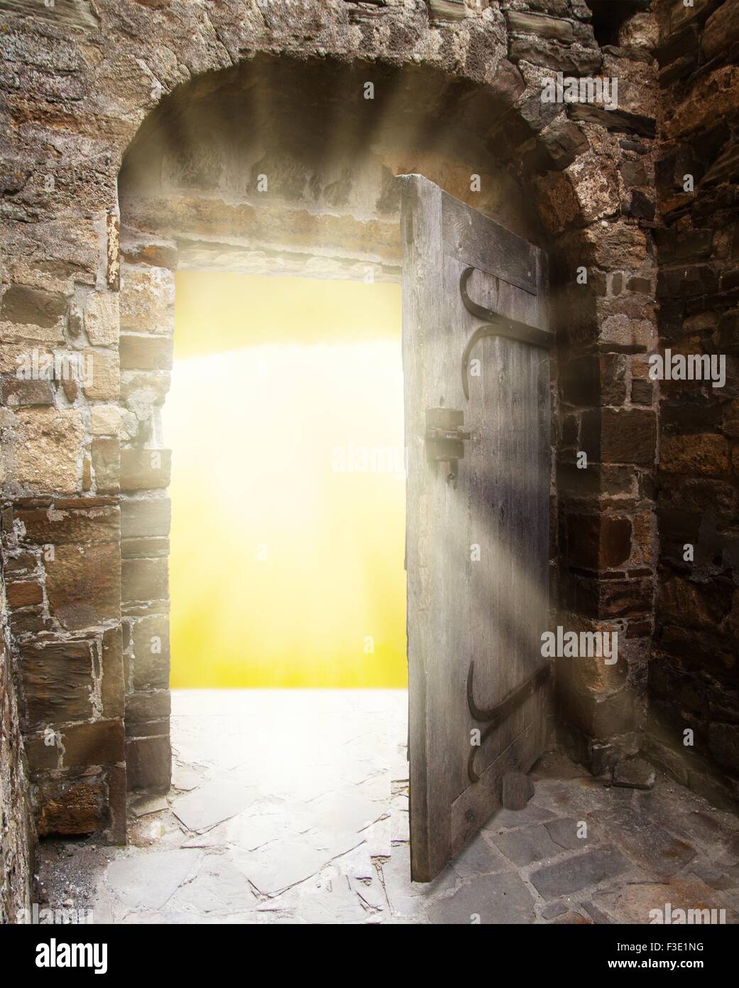 Old doors opening to show a bright light in the darkness Stock Photo ...