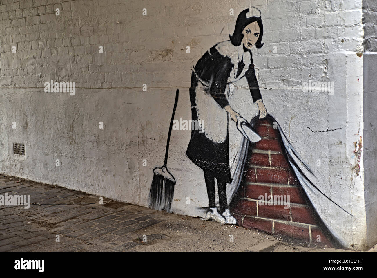 Banksy street art cleaning the streets England UK Stock Photo - Alamy