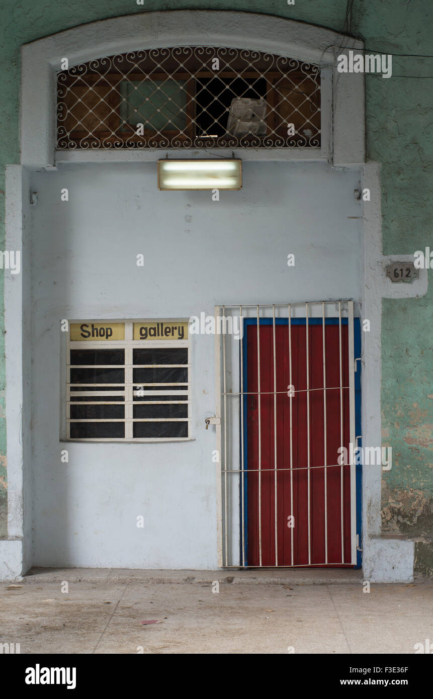 A shop and gallery storefront with bars on the window in Havana, Cuba ...