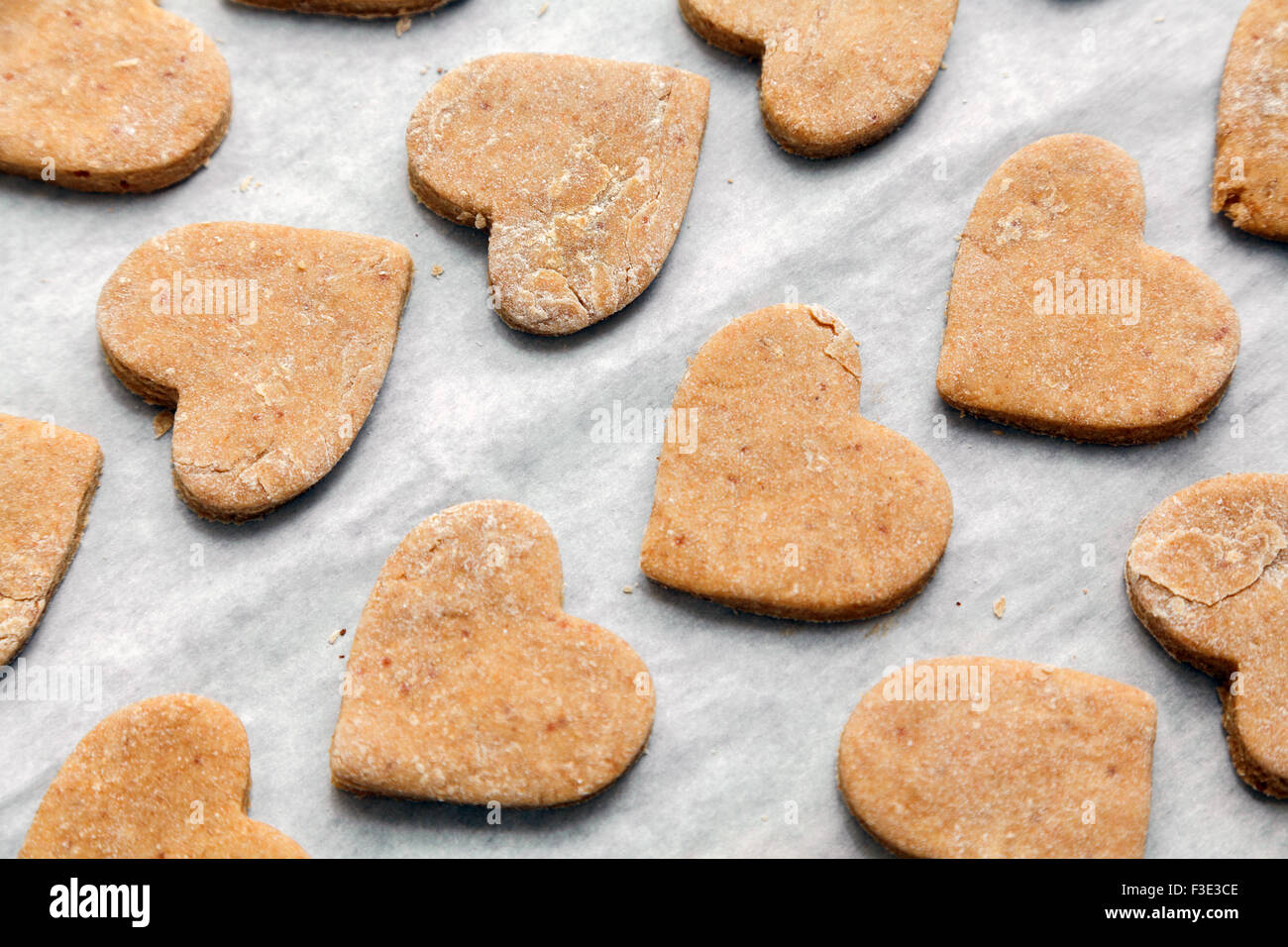 Heart shaped cookies on baking paper Stock Photo - Alamy
