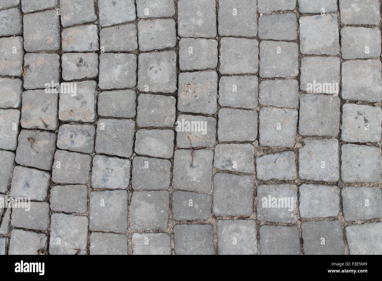 gray smooth surface of pavement tiles in shapes of little cubes Stock ...