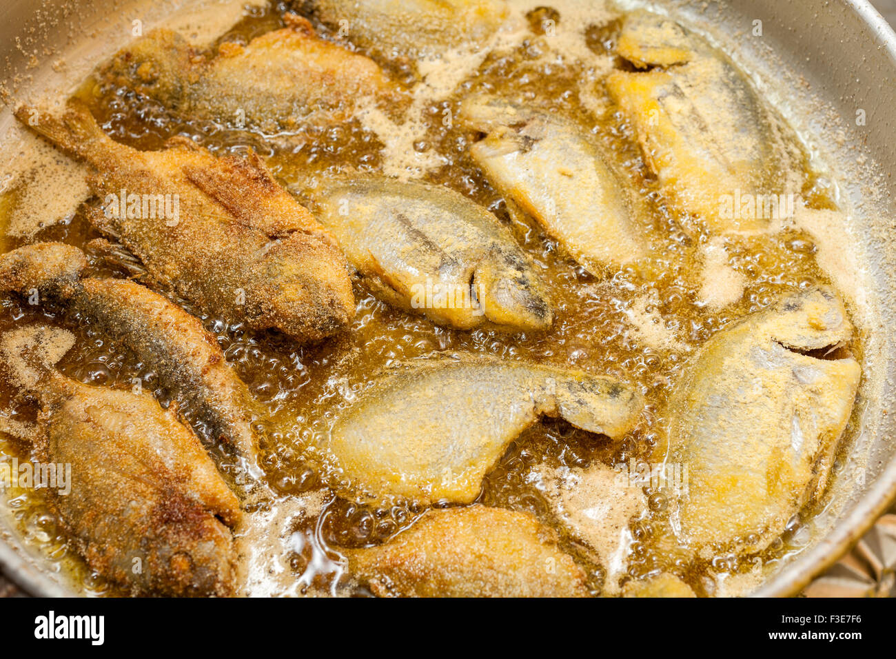 Small fishes of the Greek sea roasted in the frying pan Stock Photo - Alamy