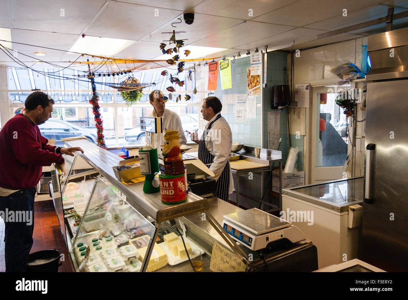 Interior of typical English wet-fish fish mongers shop. View along ...
