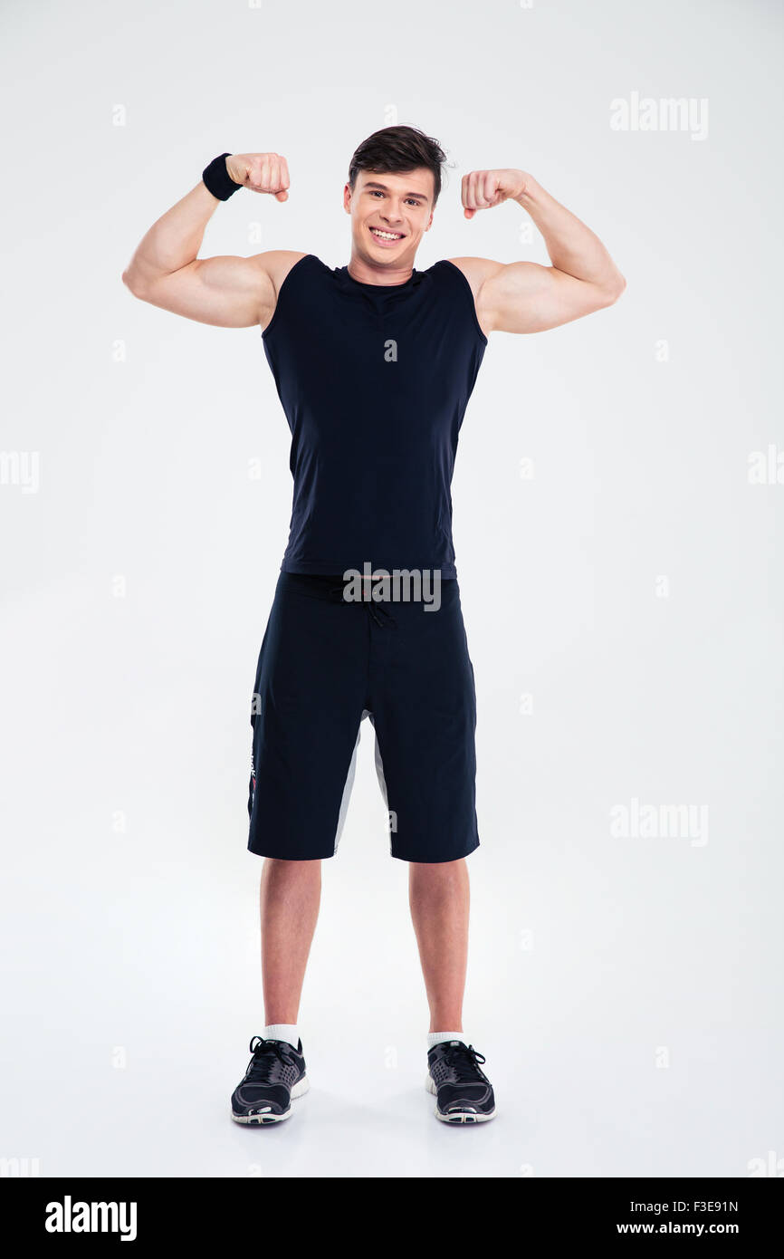 Full length portrait of a smiling man showing his biceps isolated on a ...