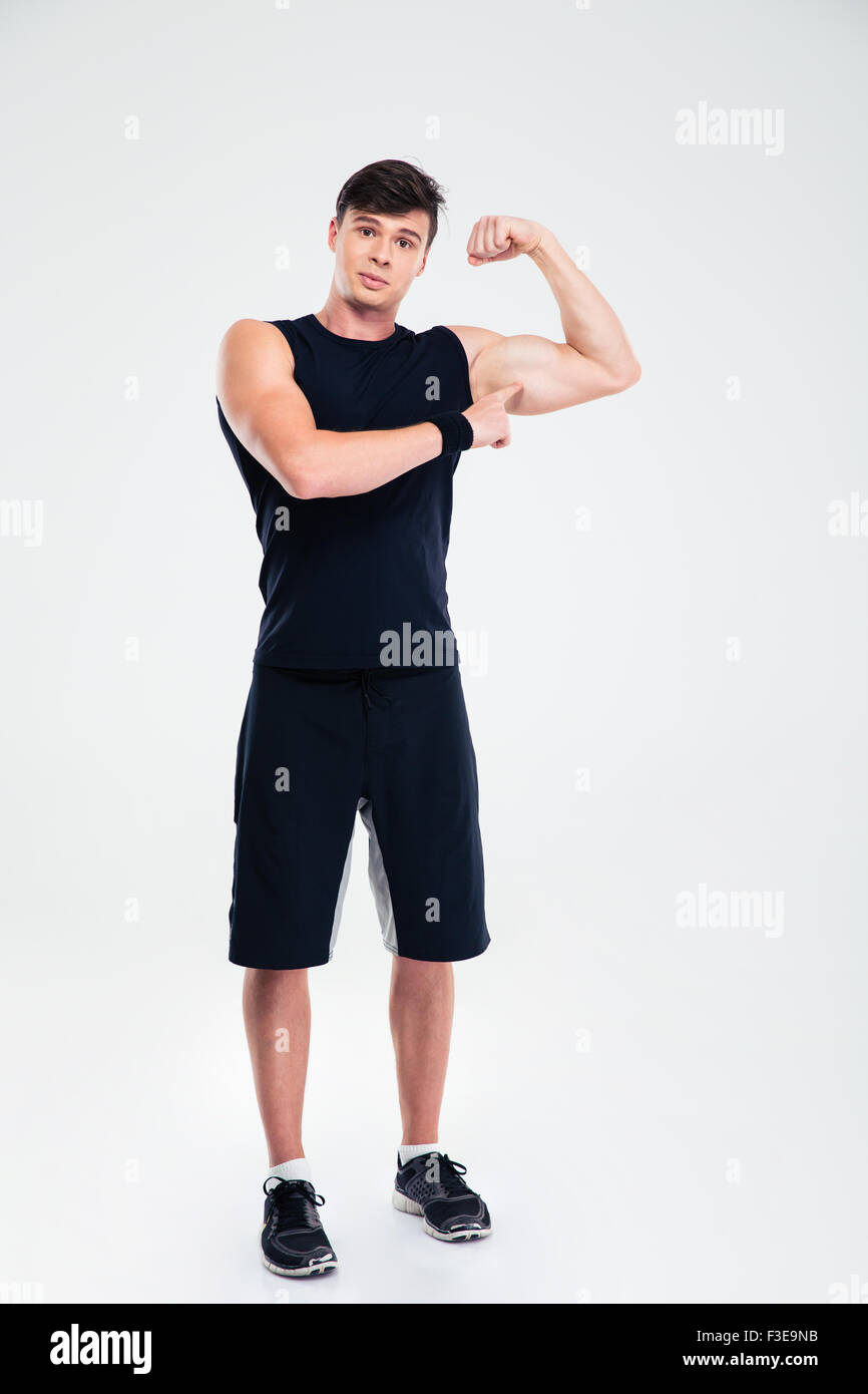 Full length portrait of a fitness man showing his biceps isolated on a ...