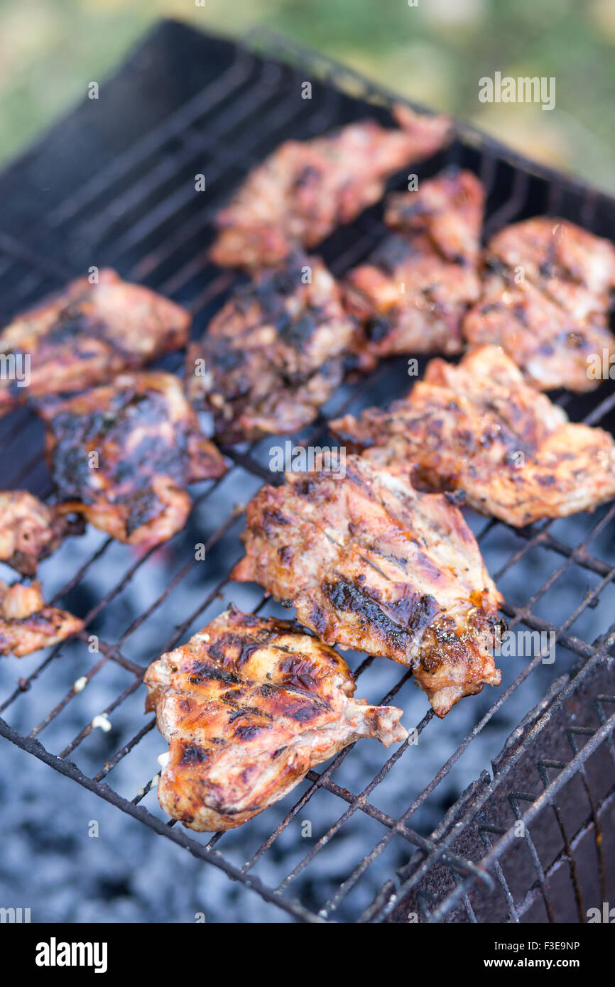Roasted barbecue meat on charcoals of grill. Recipe or menu BBQ ...