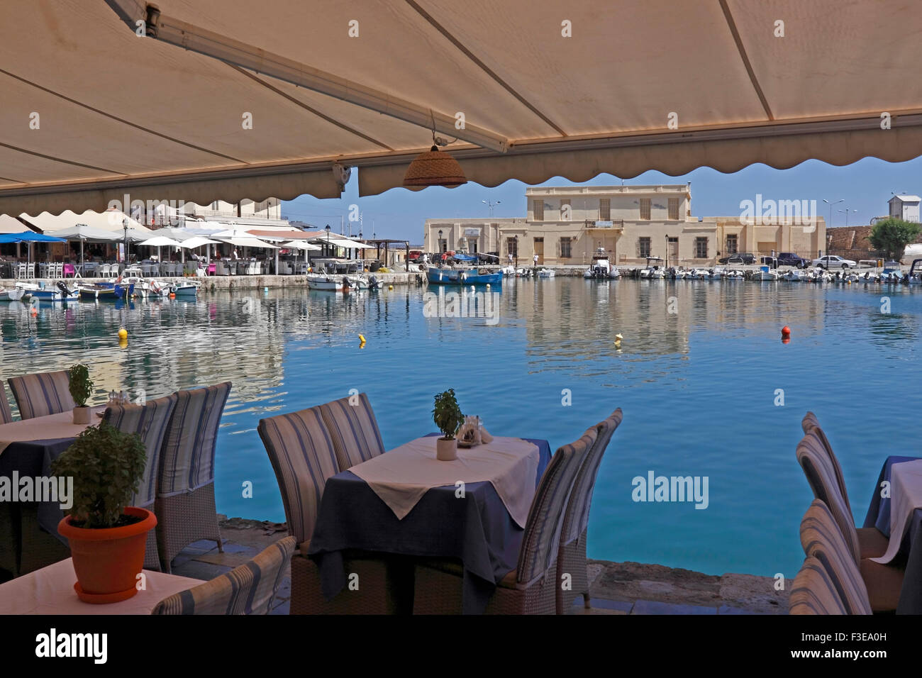 RETHYMNON VENETIAN HARBOUR FROM WITHIN A QUAYSIDE RESTAURANT. CRETE ...