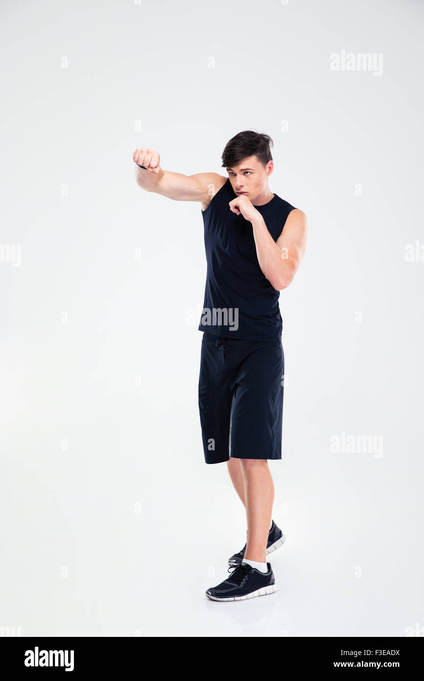 Full length portrait of a handsome man boxing isolated on a white ...