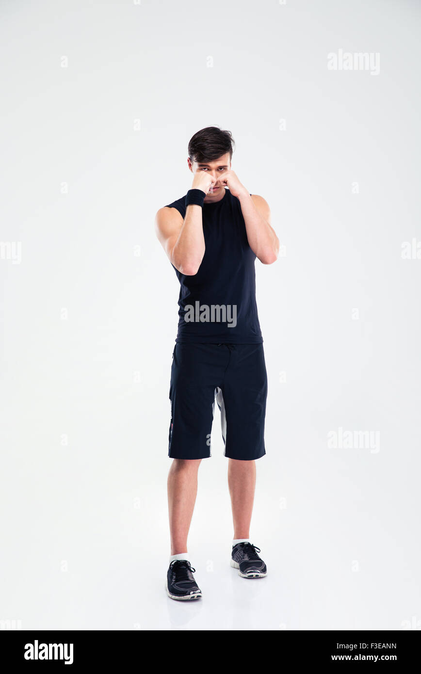 Full length portrait of a male boxer standing isolated on a white ...
