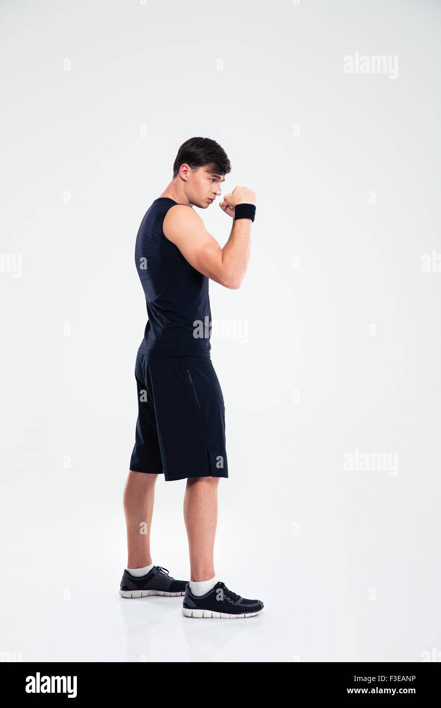 Full length portrait of young man boxing isolated on a white background ...
