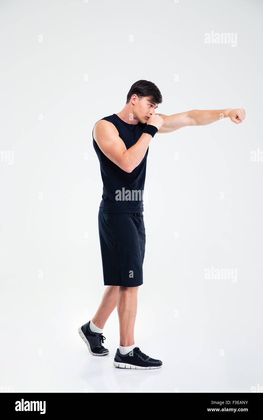 Full length portrait of a sports man boxing isolated on a white ...