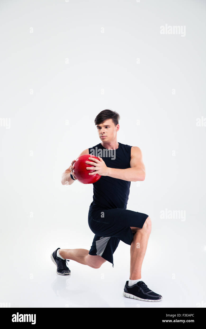 Full length portrait of sports man workout with fitness ball isolated ...
