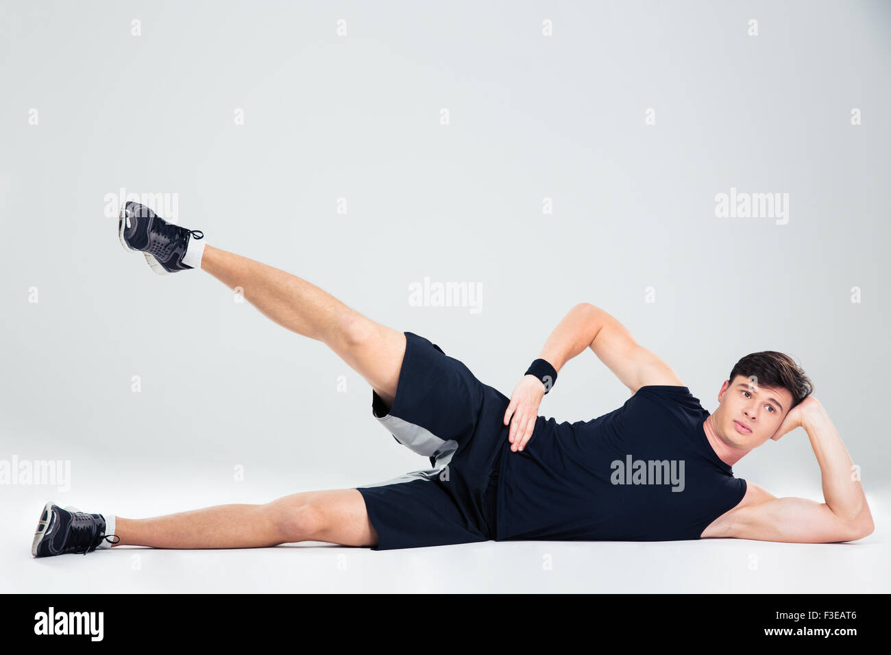 Portrait of a fitness man doing yoga exercises isolated on a white ...