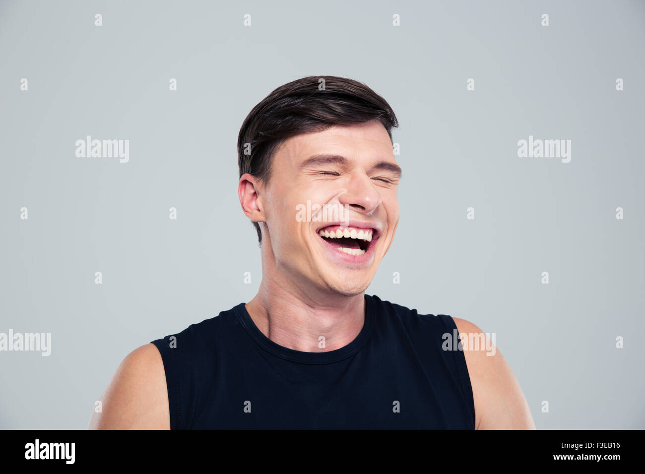 Portrait of a laughing man standing isolated on a white background ...